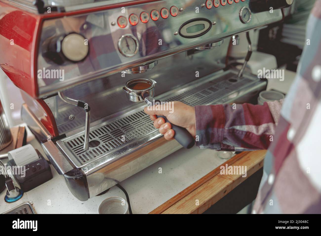 Pressed coffee tablet in holder, ready to be installed in coffee ...