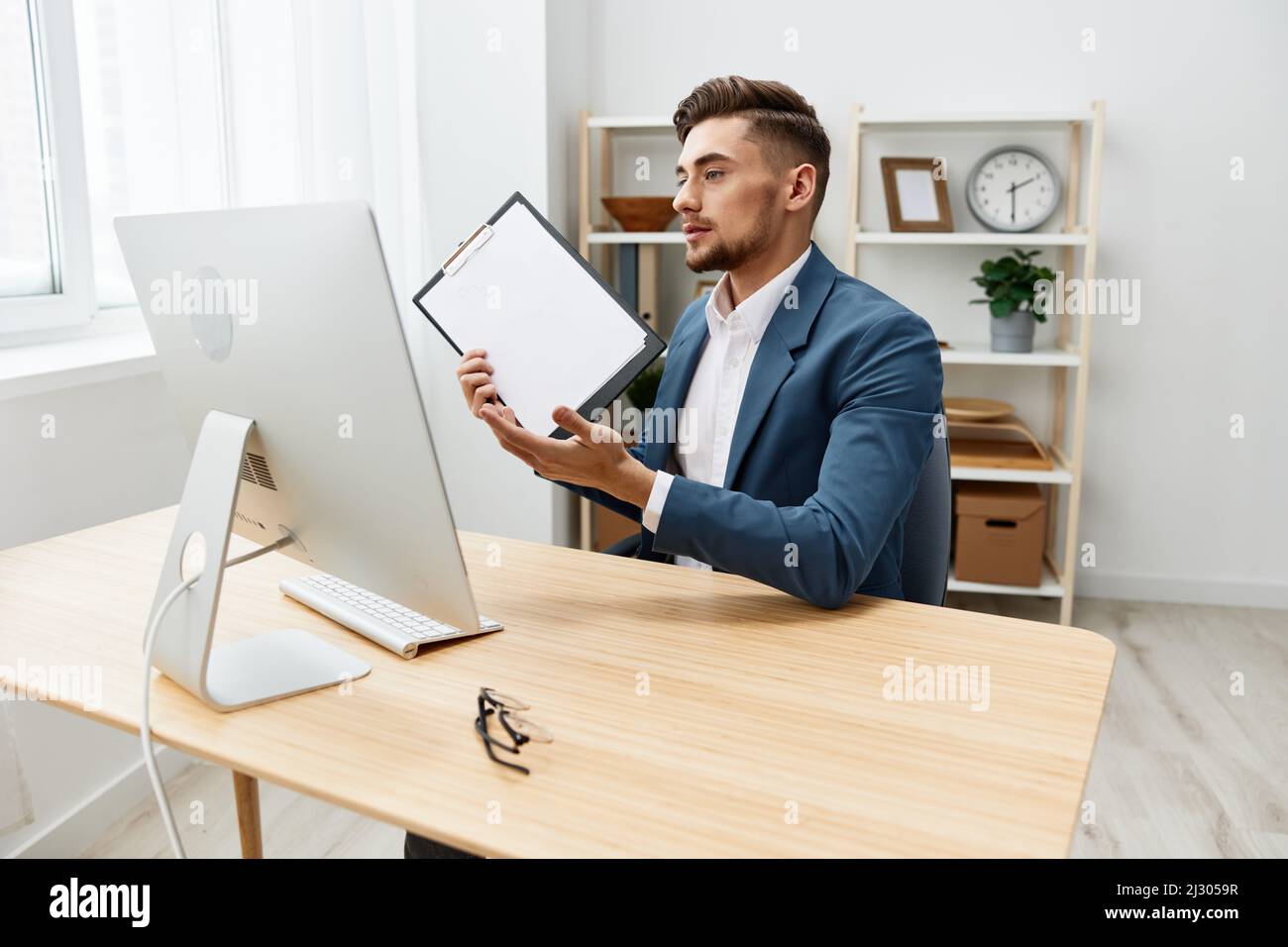 businessmen writes in documents at the desk in the office isolated ...