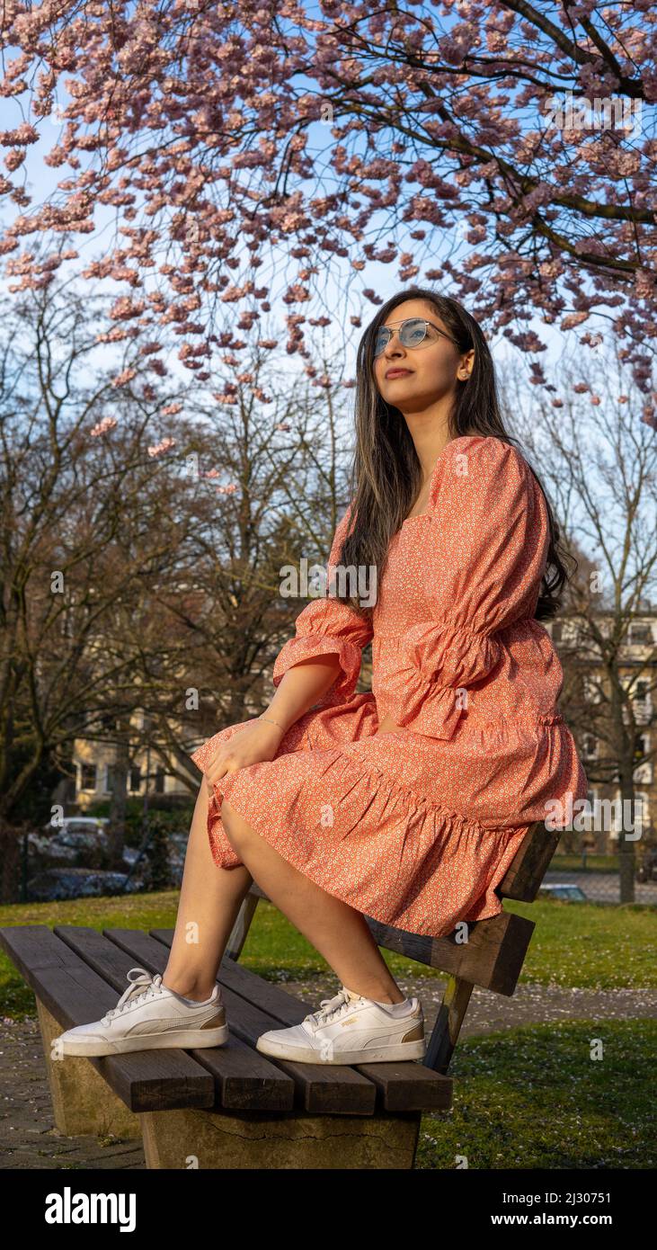 Beautiful Iranian young woman with sunglasses and colourful dress in ...