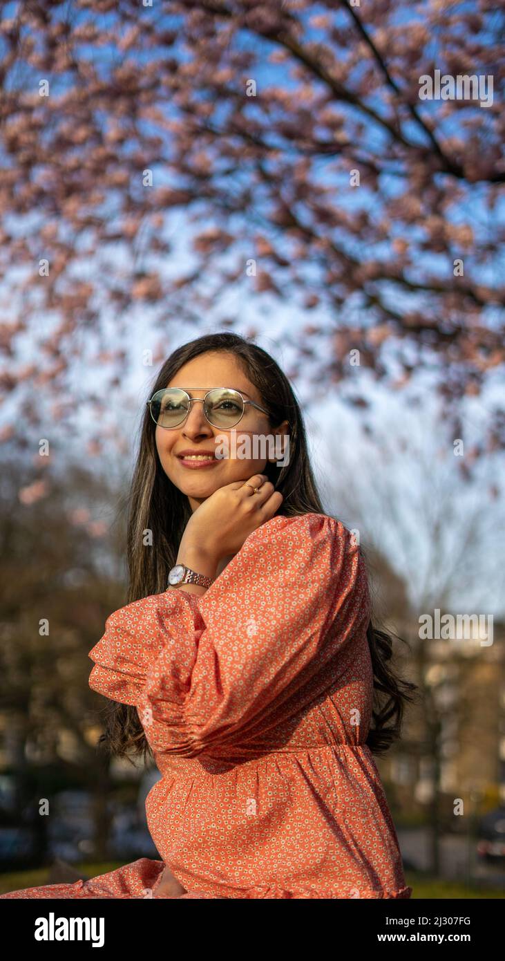 Beautiful Iranian young woman with sunglasses and colourful dress in ...