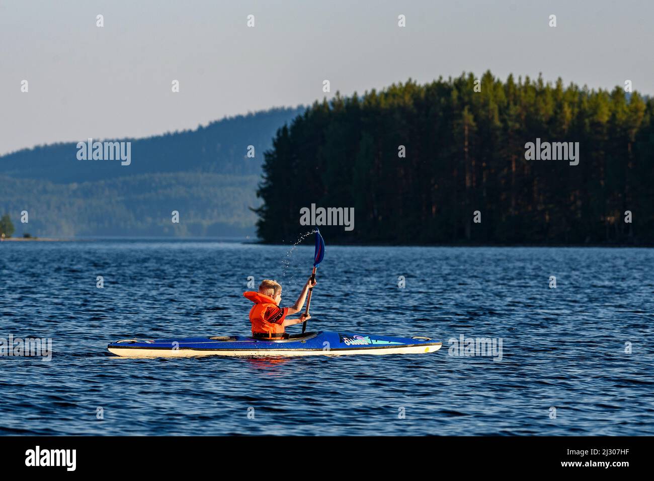 Child paddling on Lake Pielinen, Finland Stock Photo - Alamy