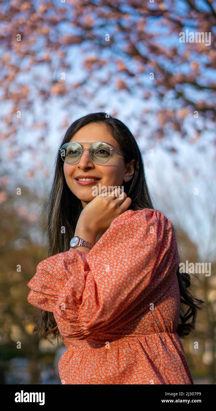 Beautiful Iranian young woman with sunglasses and colourful dress in ...
