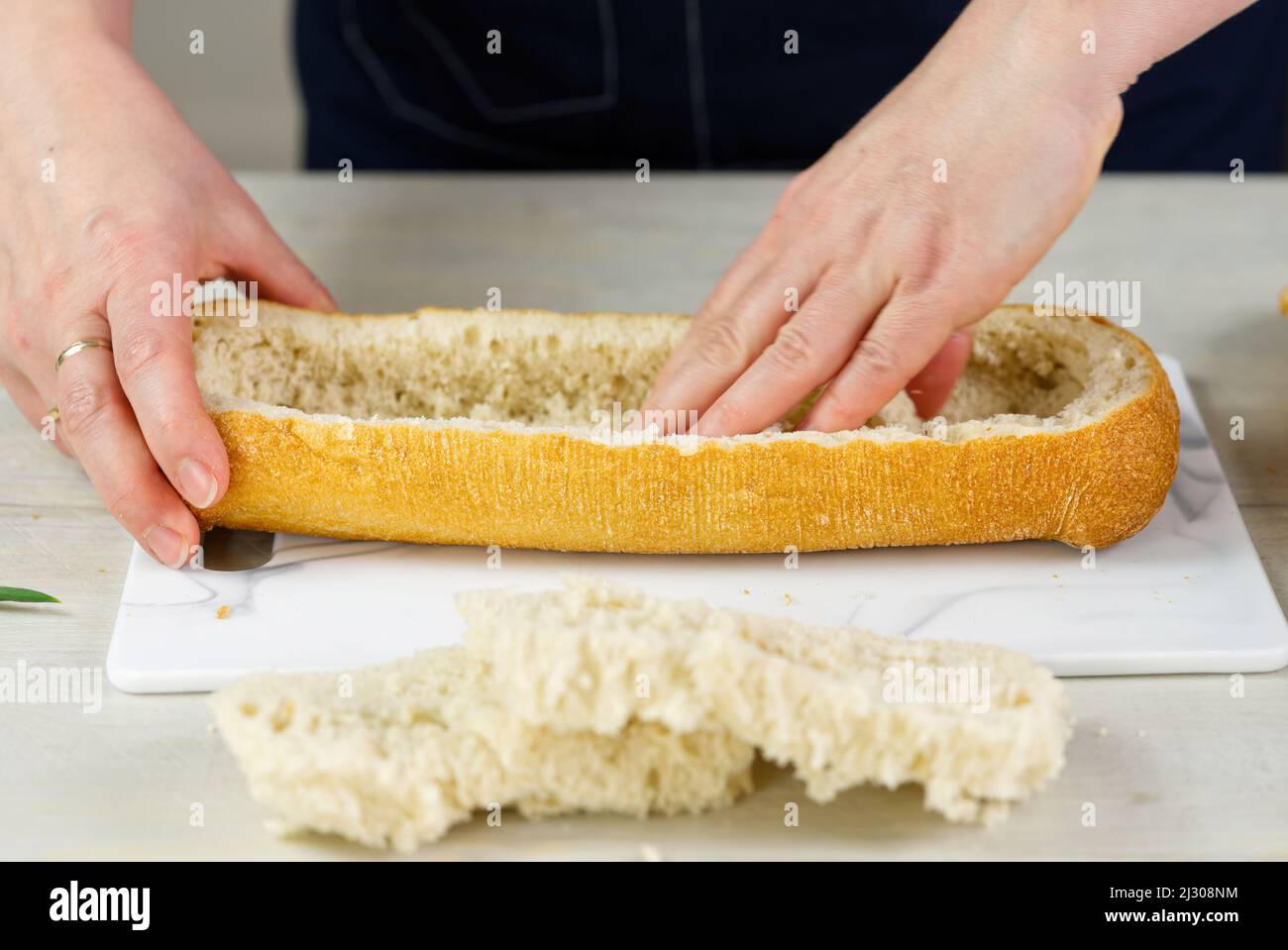 the cook cuts fresh ciabatta bread. Pulls out the pulp from the inside ...