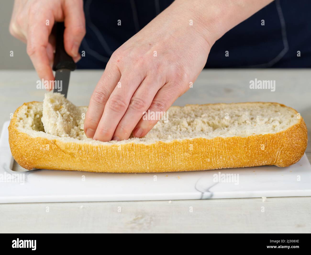 the cook cuts fresh ciabatta bread. Pulls out the pulp from the inside ...