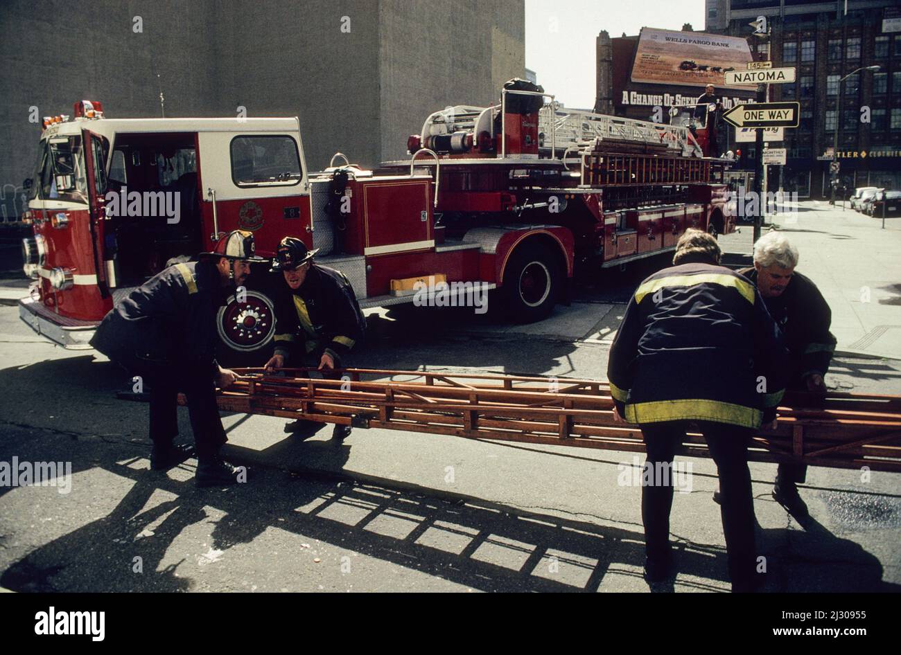 Firefighters of the San Francisco Fire Department loading a ladder on ...