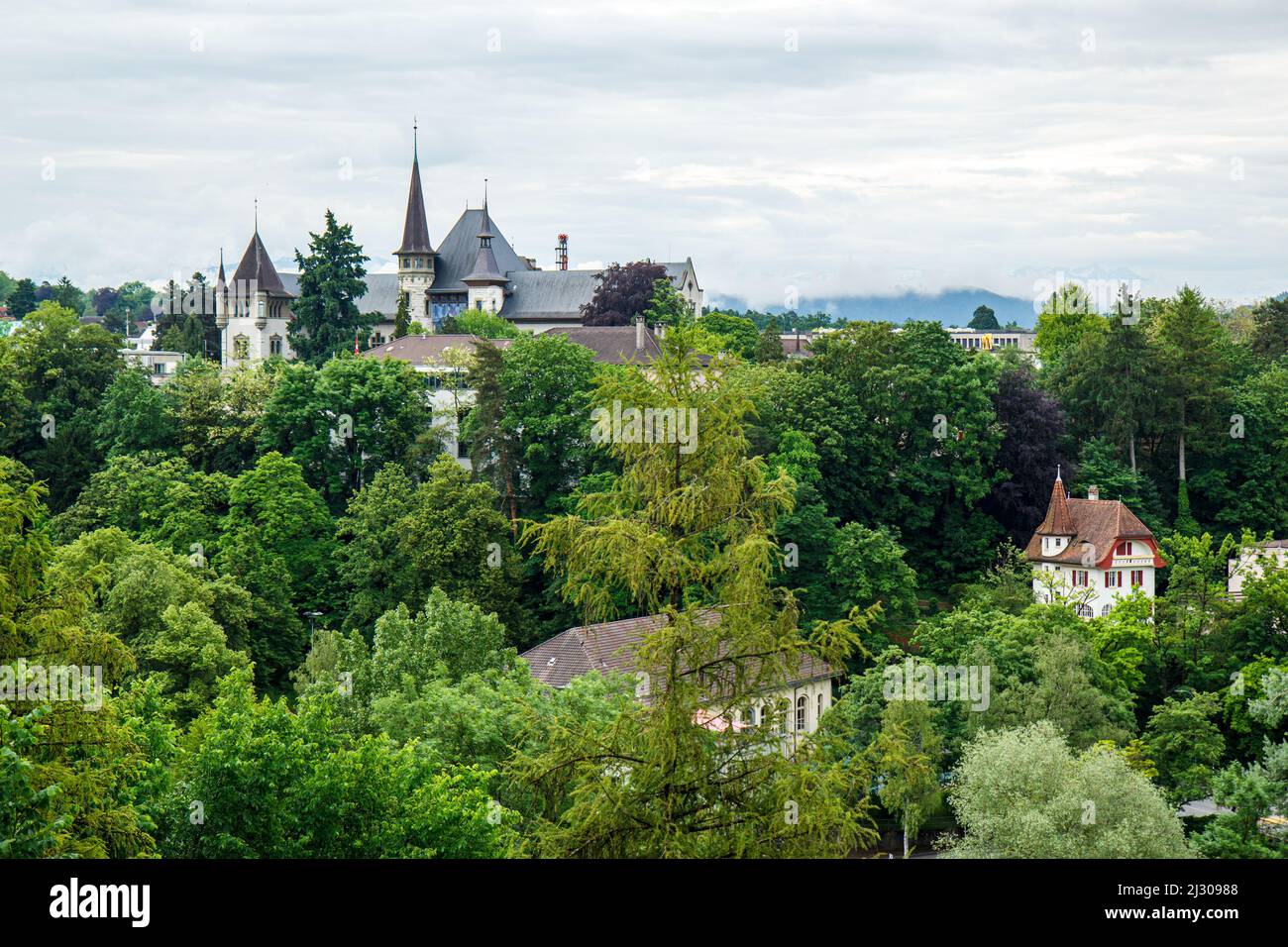 The Bern Historical Museum peaking behind the trees in Switzerland ...