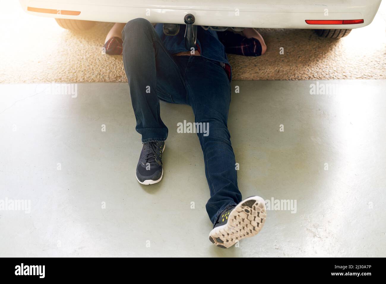 Getting his car back on the road. High angle shot of an unrecognizable ...