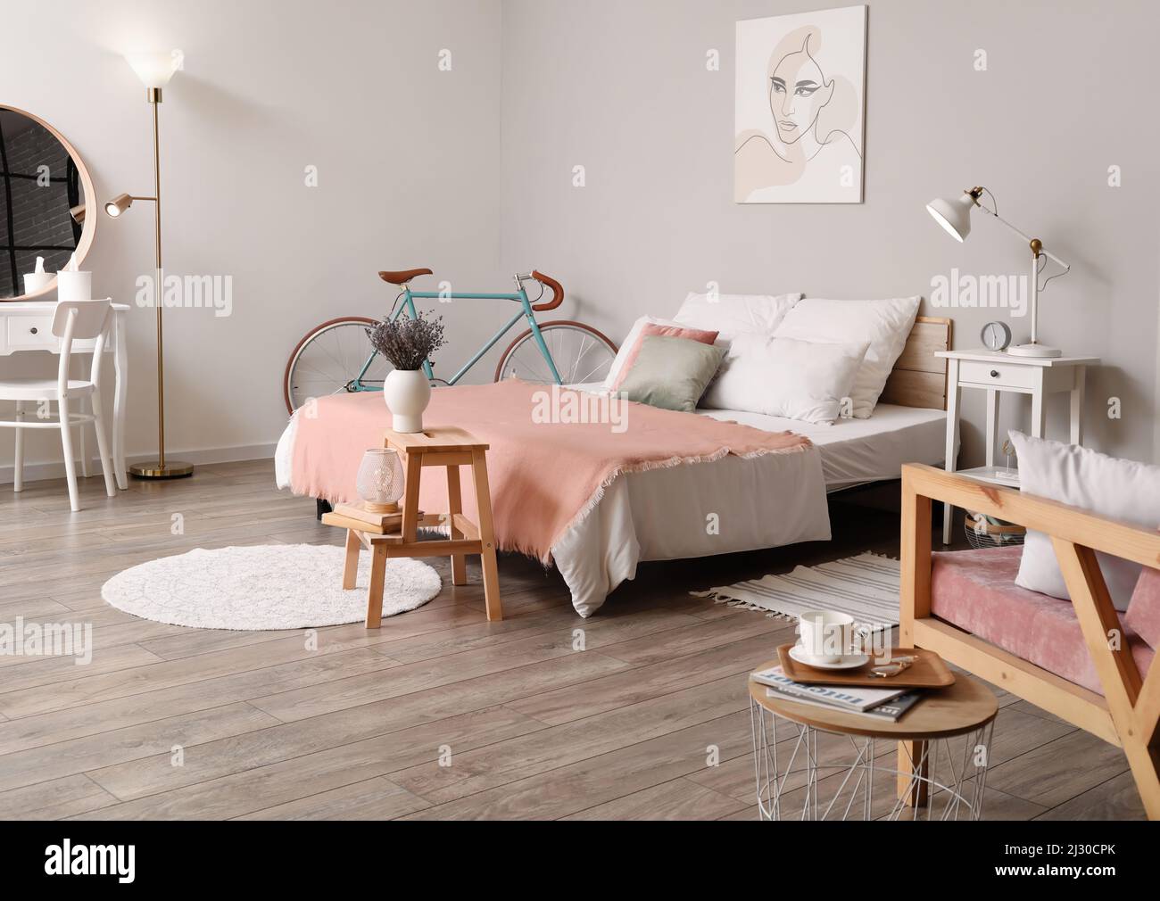 Interior of bedroom with comfortable bed and bicycle Stock Photo - Alamy