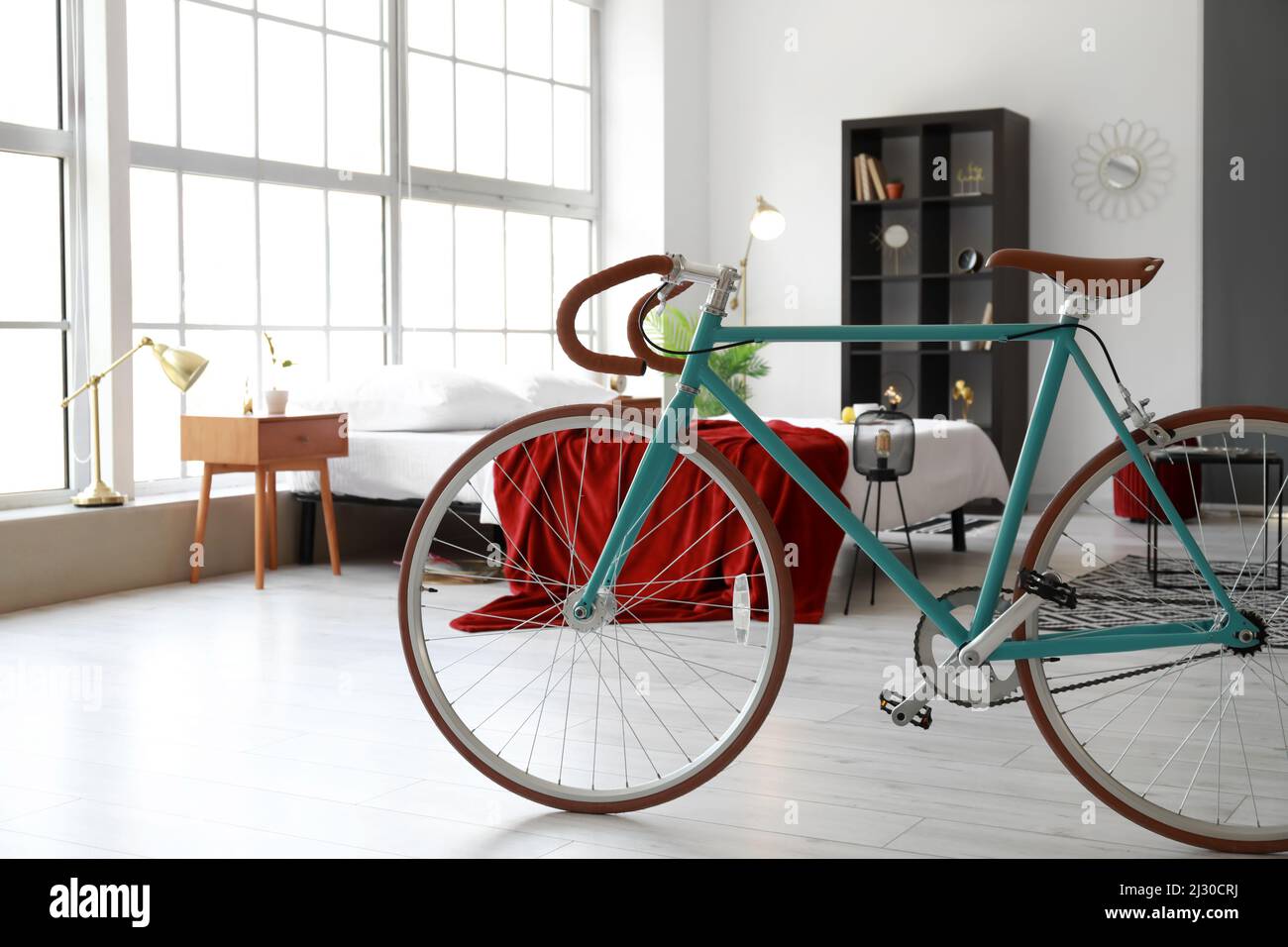 Interior of modern stylish bedroom with bicycle Stock Photo - Alamy