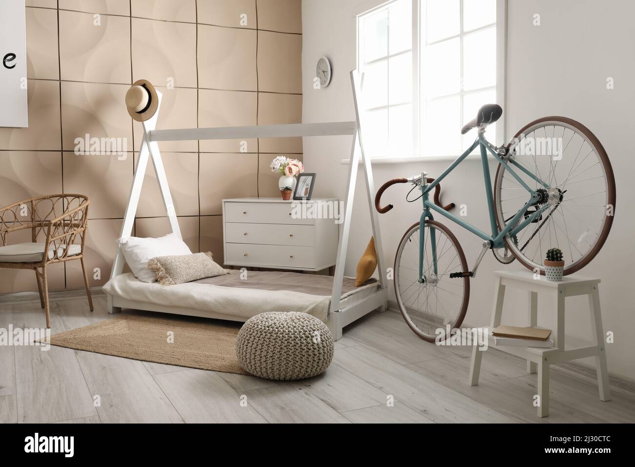 Interior of bedroom with stylish bed and bicycle Stock Photo - Alamy