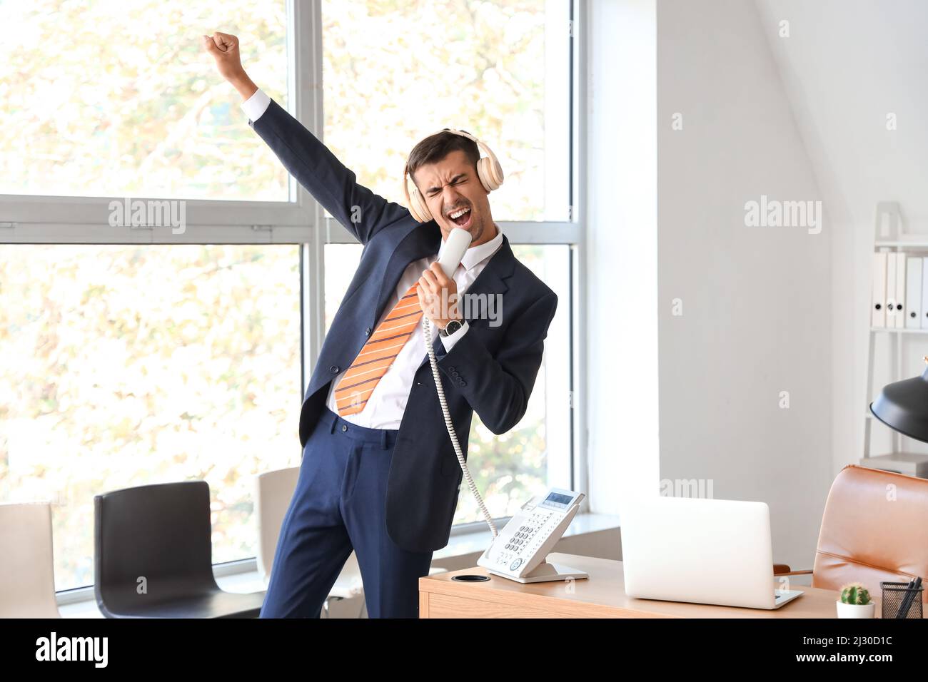 Carefree office employee in headphones hi-res stock photography and ...