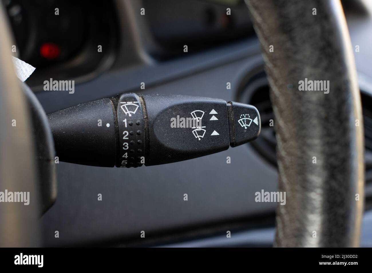A soft focus of a windscreen wiper adjustment control lever in a modern ...