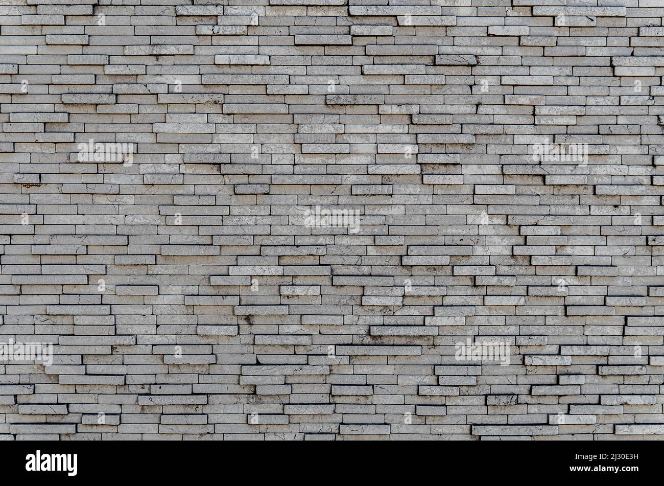 Gray brick wall. Background of rectangular gray tiles of different ...