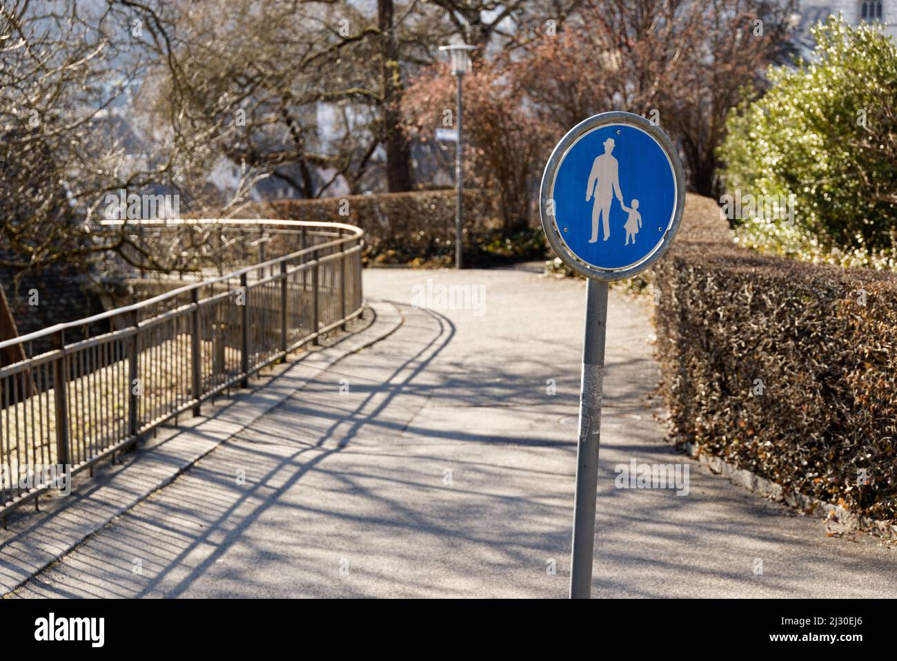 blue footpath sign, traffic sign, white painted man with child on blue ...