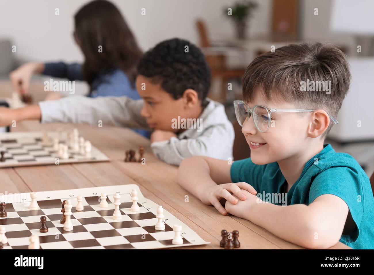 Little children playing chess during tournament in club Stock Photo - Alamy