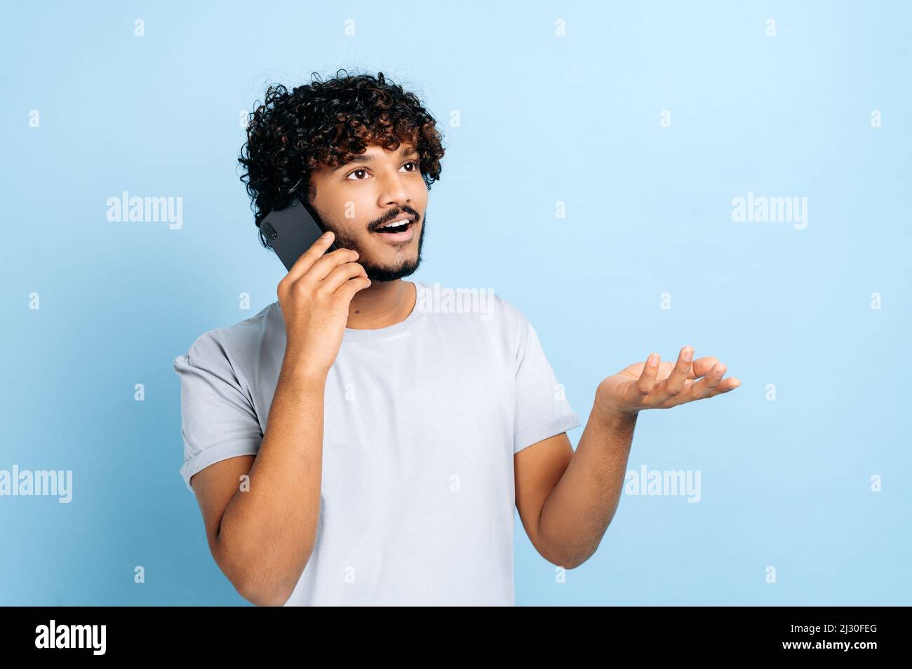 Mobile phone conversation concept. Positive arabic or indian attractive ...