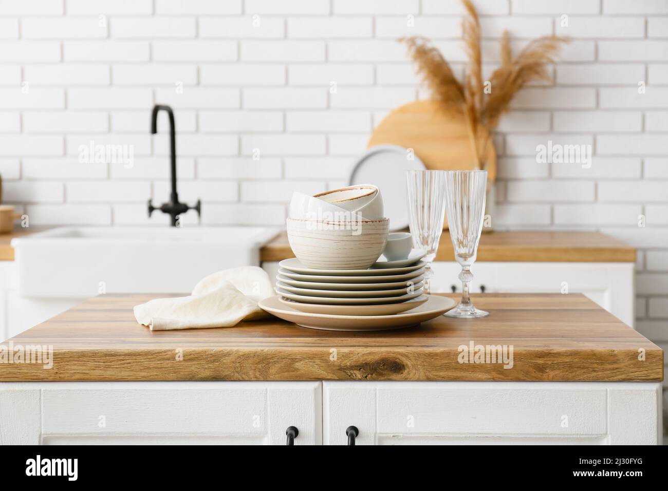 Set of clean tableware in kitchen Stock Photo - Alamy