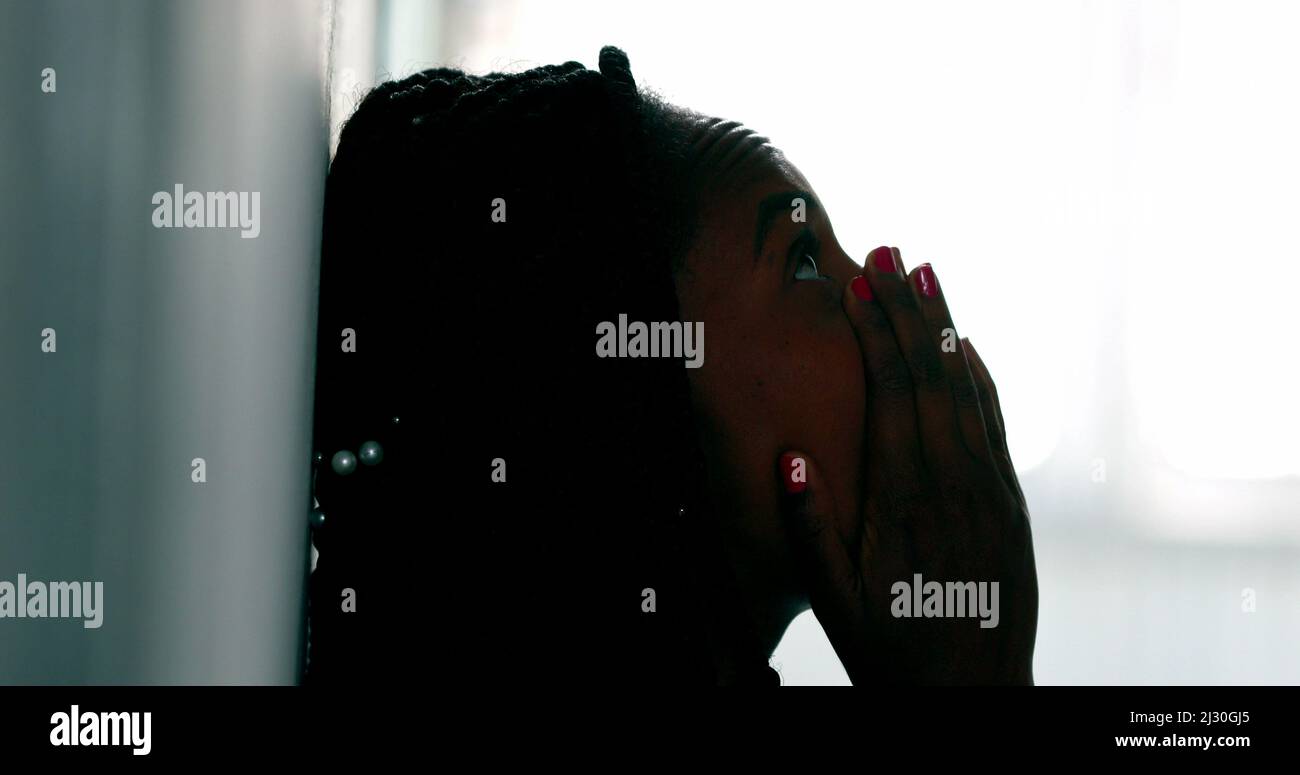 Worried African woman feeling anxiety. Silhouette black woman in ...