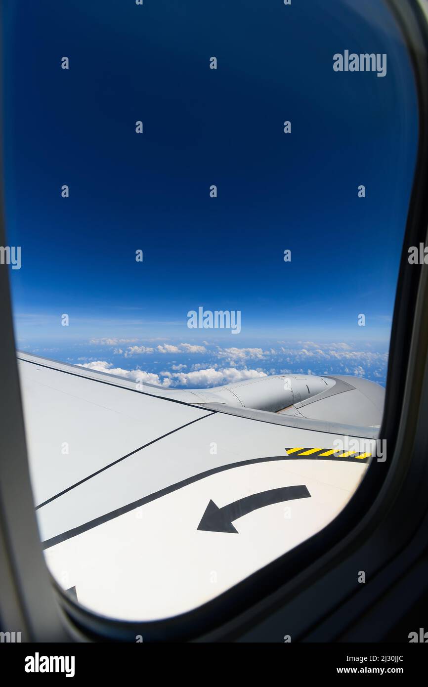 View through the window of a plane of the wing and turbine during a ...