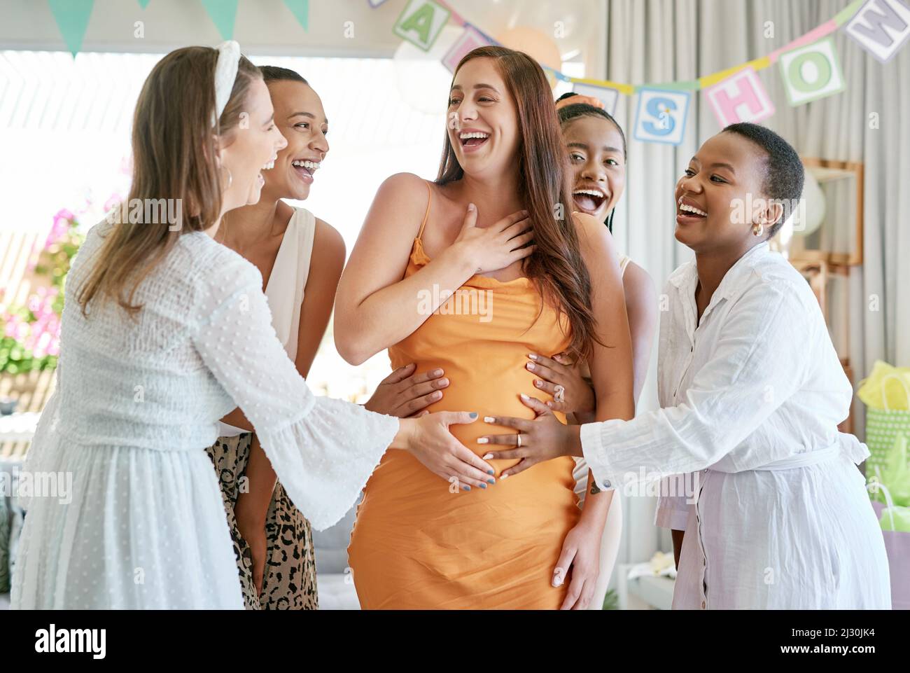 This is the best baby shower. Shot of a group of friends celebrating at ...