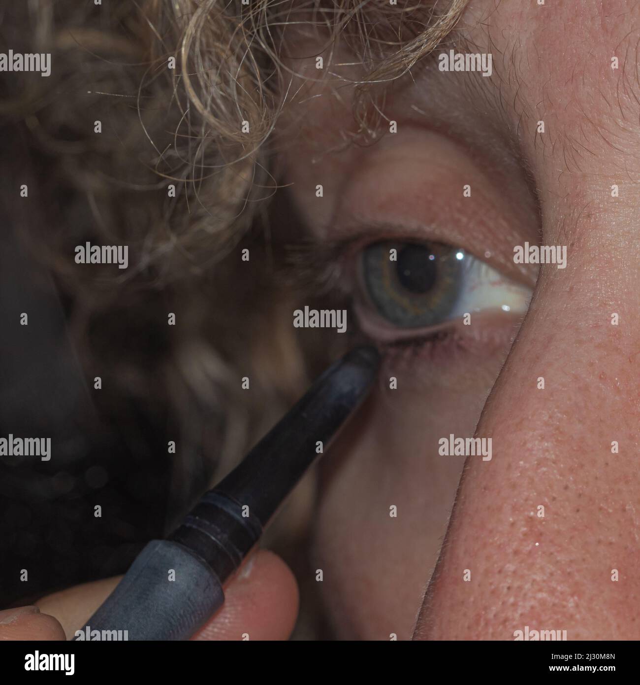 Applying eyeliner for enhancing eye makeup on a close-up view Stock ...