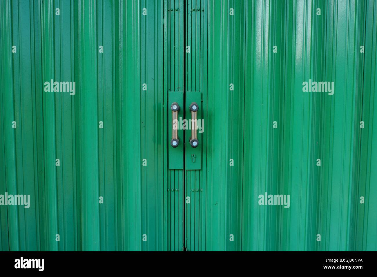 A green, metal gate background with rustic, silver handles Stock Photo ...