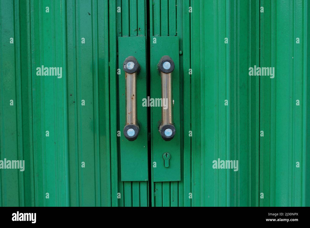 A green, metal gate background with rustic, silver handles Stock Photo ...