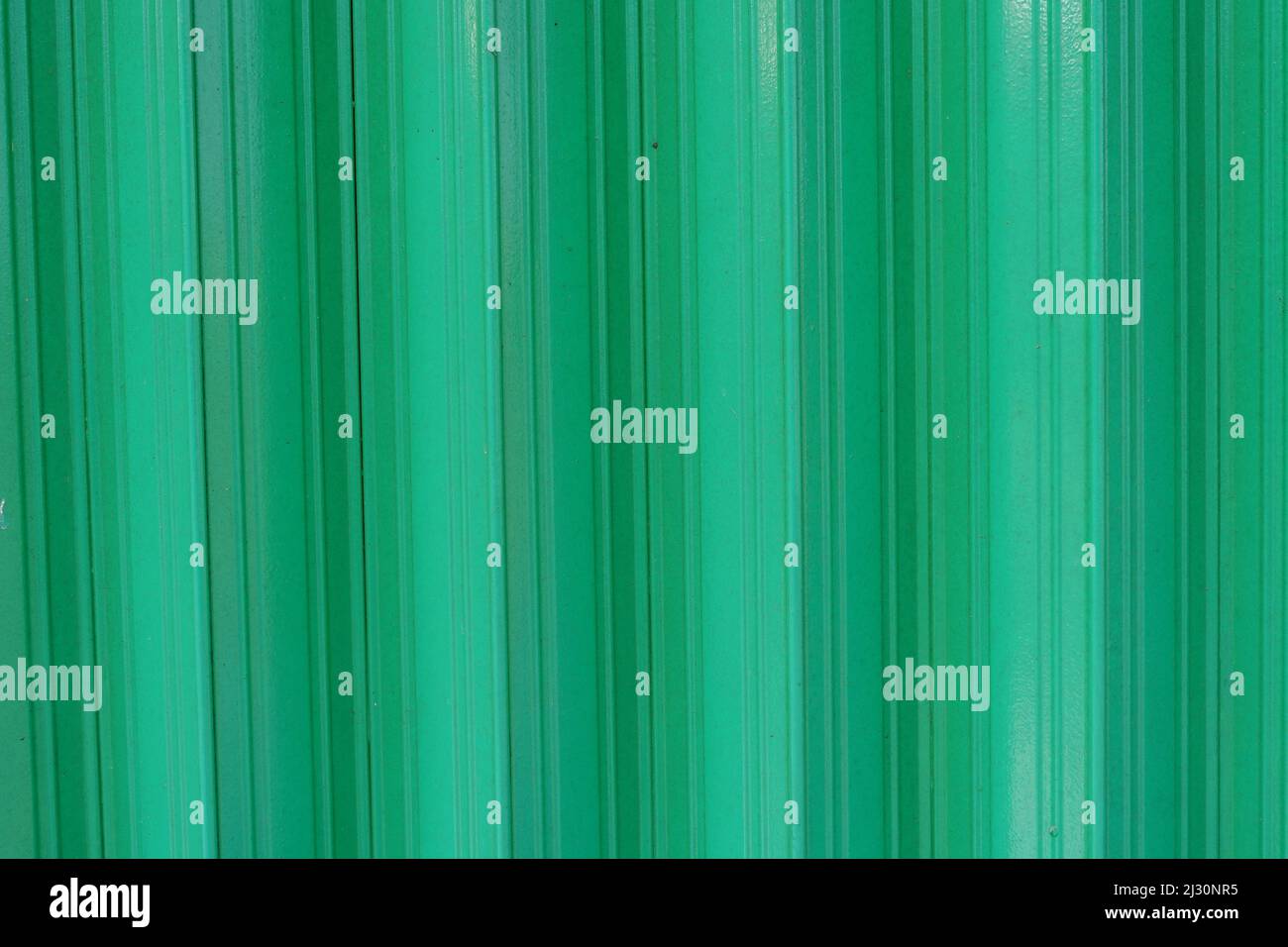 A green, metal wall background with white, vertical line patterns Stock ...