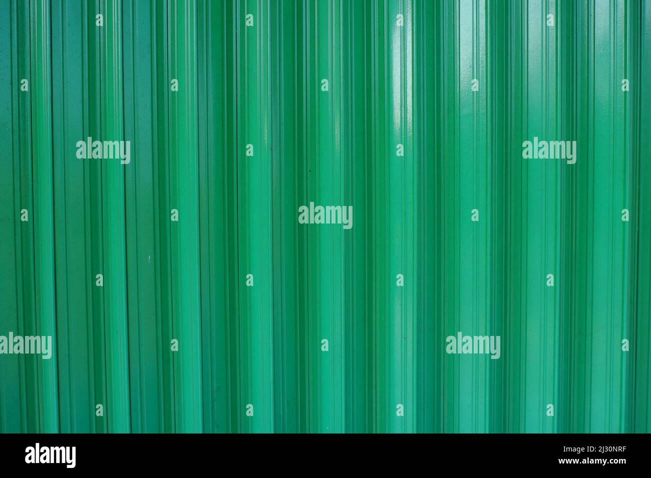A green, metal gate background with vertical lines Stock Photo - Alamy