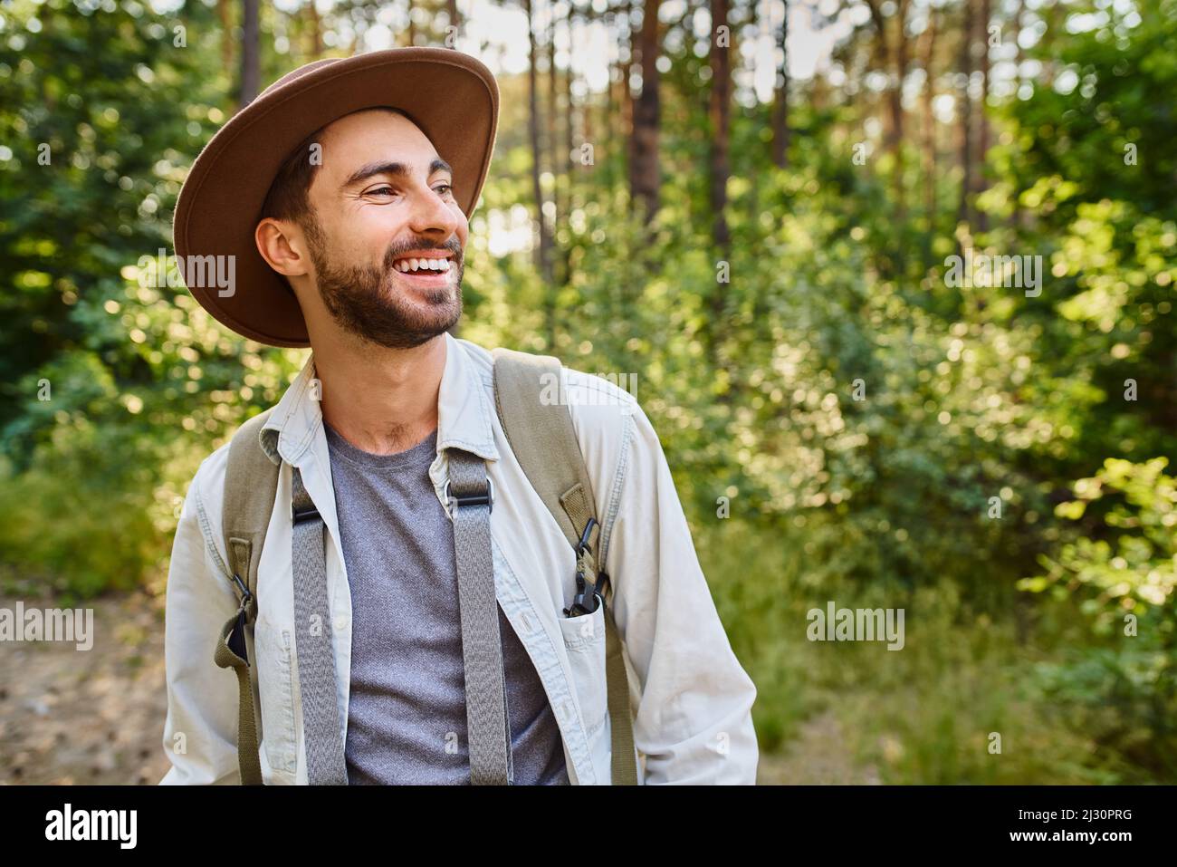Handsome young man hiking in forest 20s adult hi-res stock photography ...