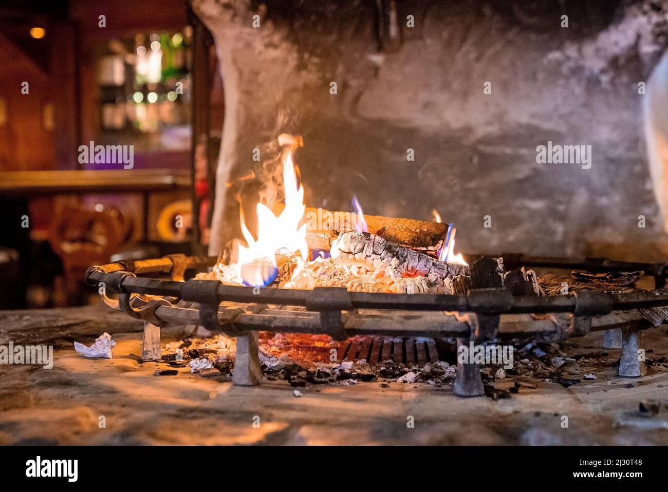 Burning fire place in rustic restaurant during winter Stock Photo - Alamy