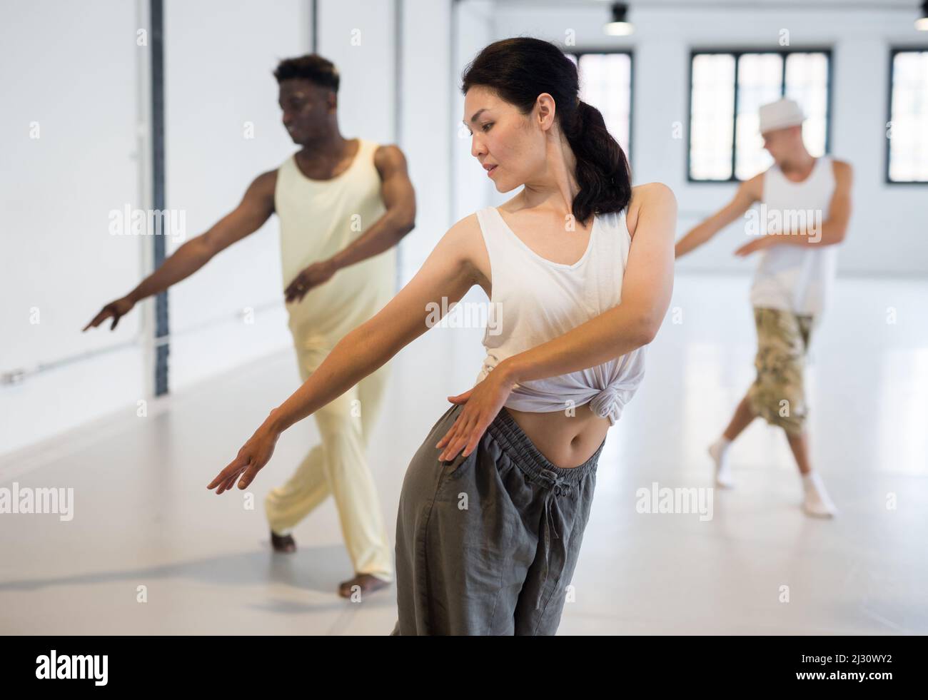 Four dancers exercising contemporary dance movements Stock Photo - Alamy
