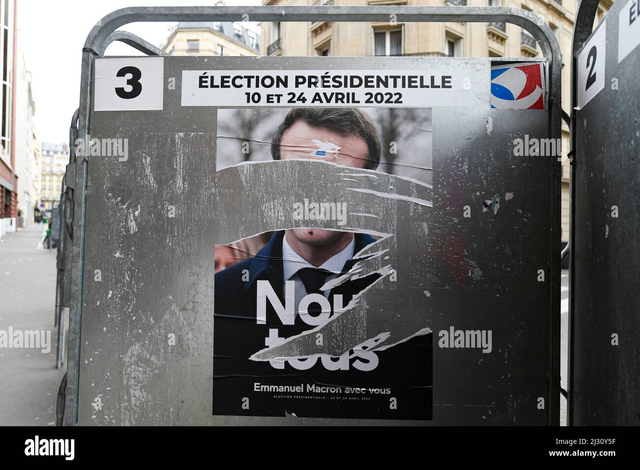 Torn official campaign poster of Emmanuel Macron, on an electoral ...