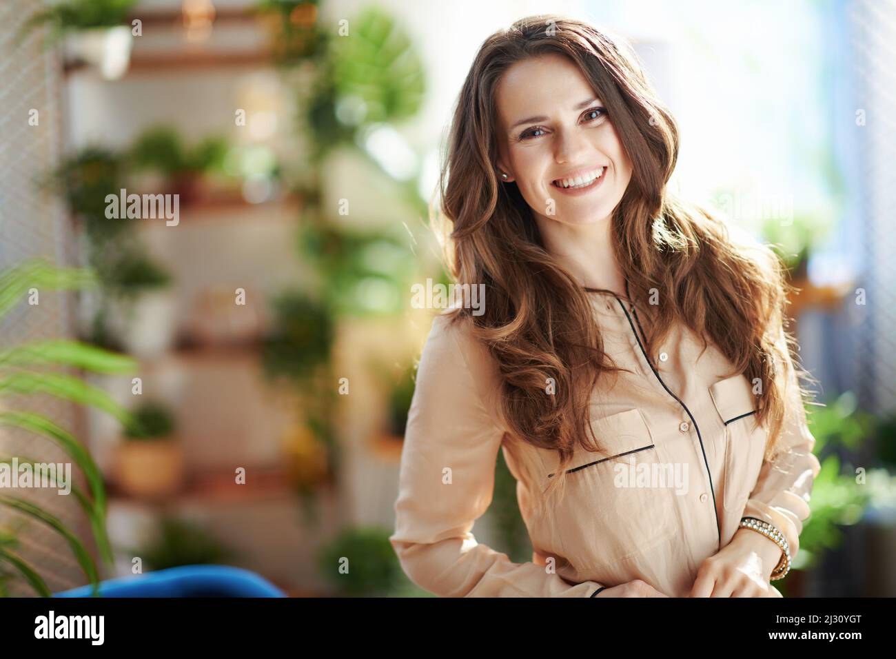 Green Home. Portrait of smiling trendy 40 years old woman with long ...