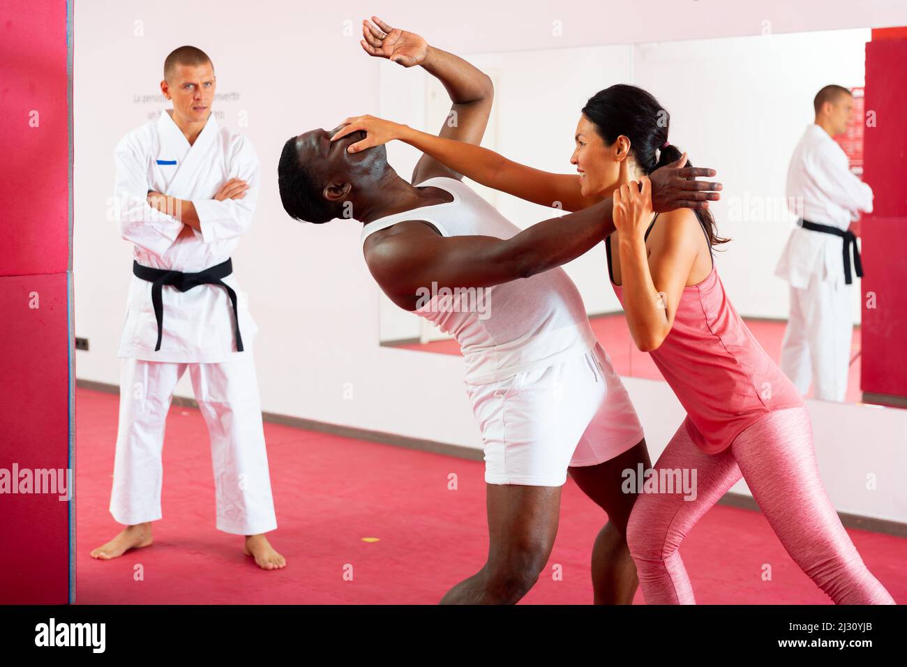 Woman painful eye blow to african american man in self defense training Stock Photo - Alamy