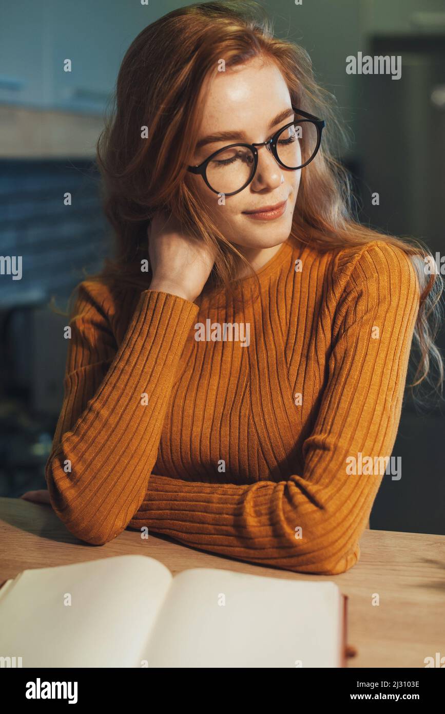 Woman dreamy reading book hi-res stock photography and images - Alamy