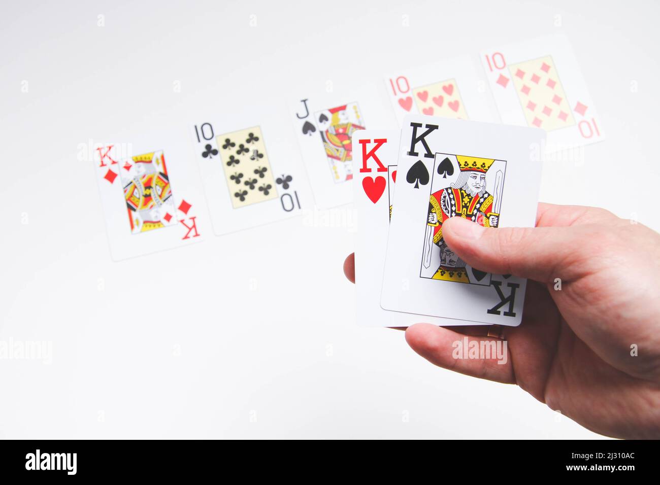 A deck of playing cards in hand. The player deals cards. Poker game ...