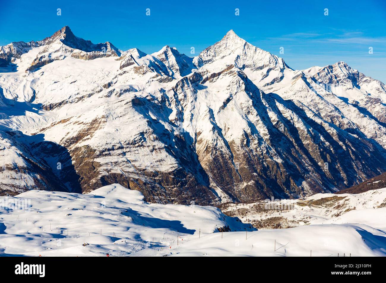 Pennine Alps highlands near Zermatt with snow-capped mountains and ski ...