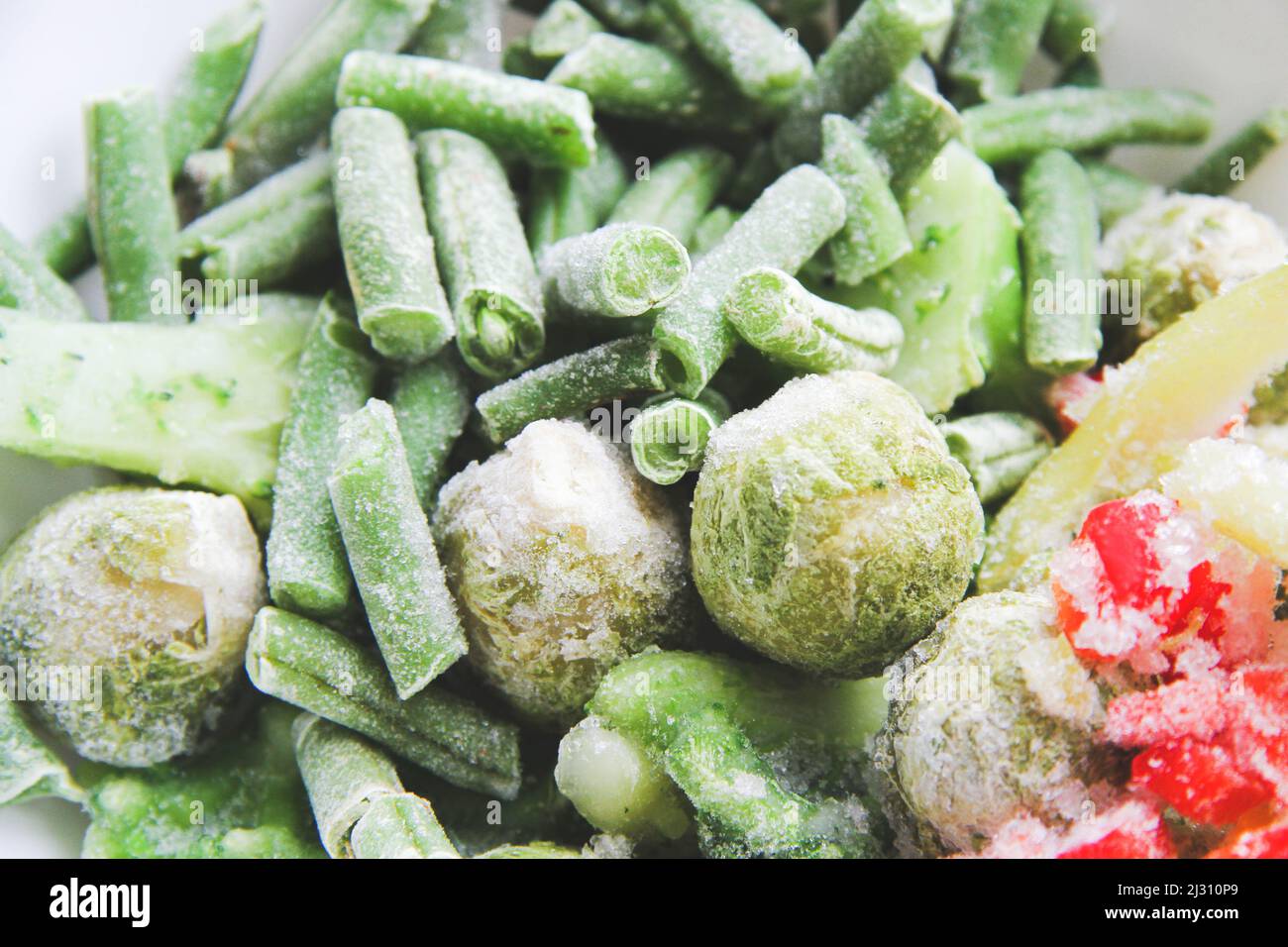 Frozen vegetables close up. Vegetables in the fridge. Ice on vegetables ...