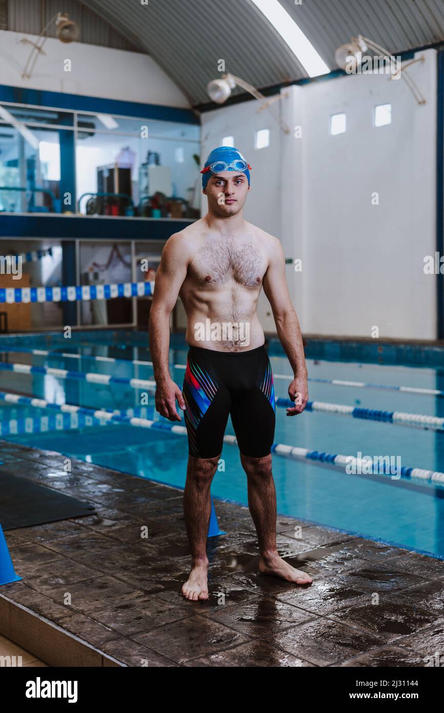 hispanic young man swimmer athlete wearing cap in a swimming training ...
