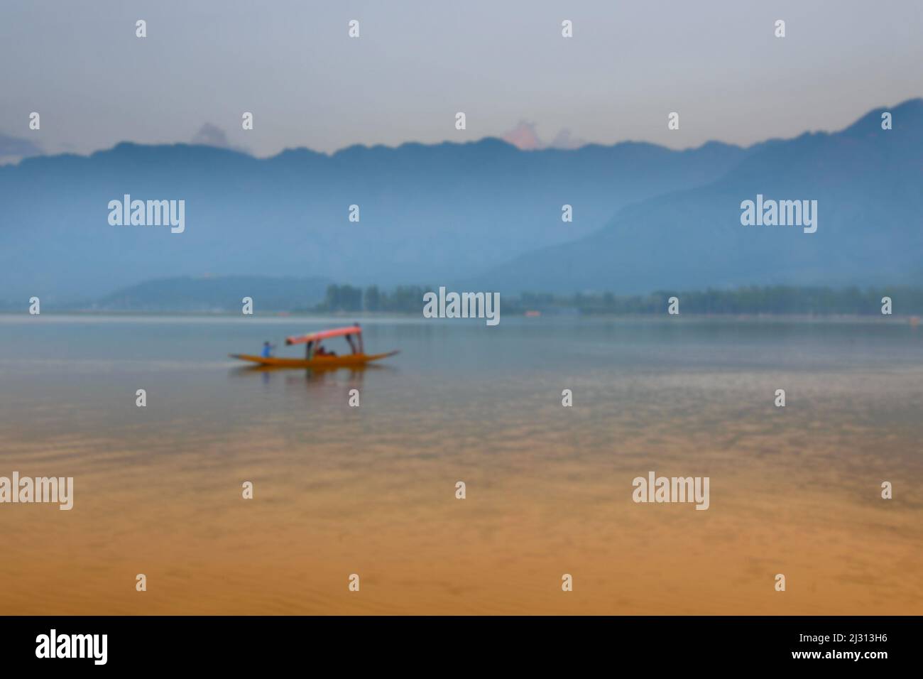 Blurred image of reflection of Himalayan mountains on Dal Lake ...