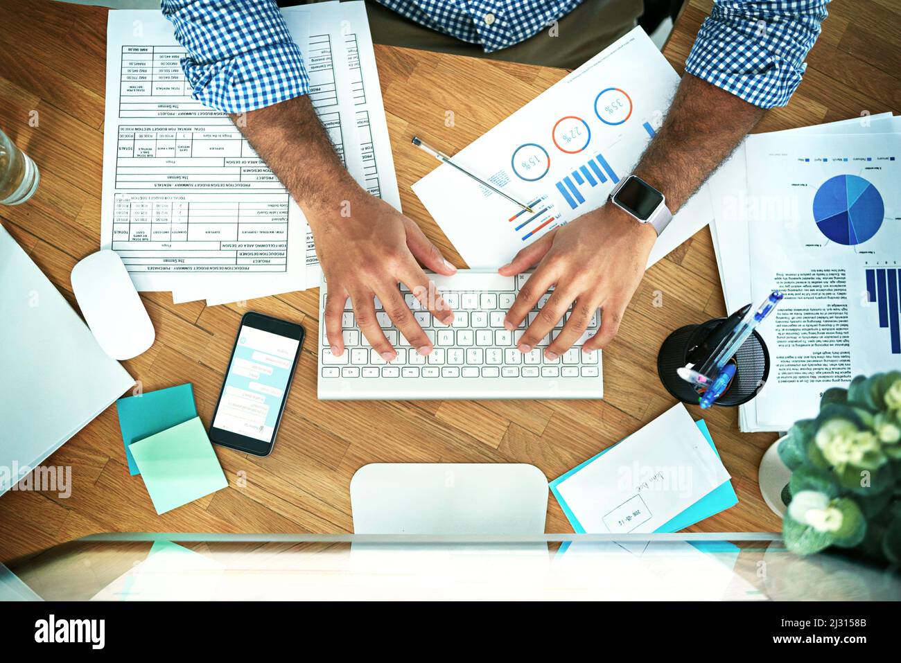 His hands are magic on a keyboard. High angle shot of an unrecognizable ...