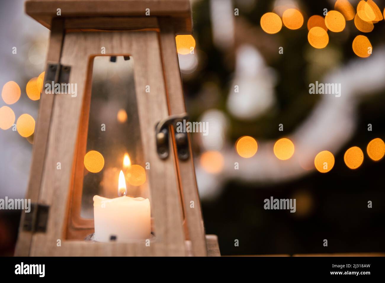 A candle burns closed inside a decorative lantern on Christmas Day ...