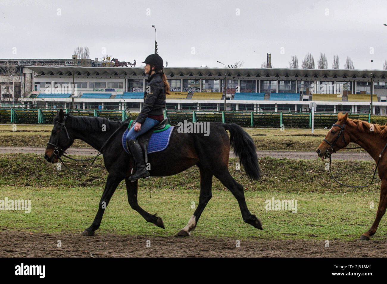 A woman rides a horse at the Kyiv Racecourse, Kyiv, capital of Ukraine ...