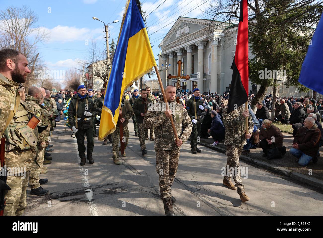Soldiers carry flags during a funeral ceremony for Ukrainian defenders ...
