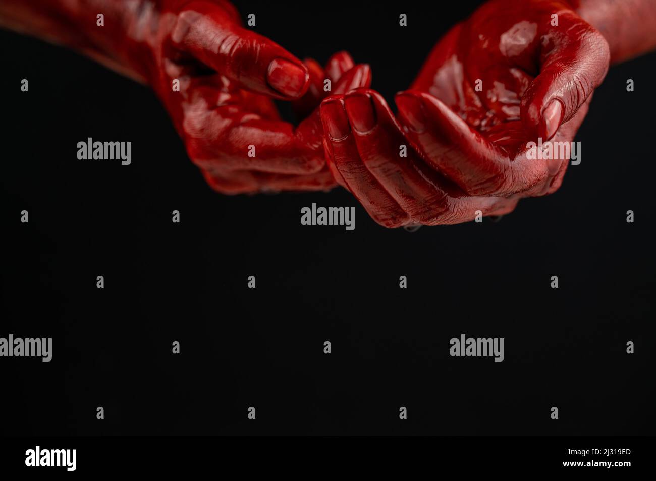 Women's hands in blood on a black background Stock Photo - Alamy