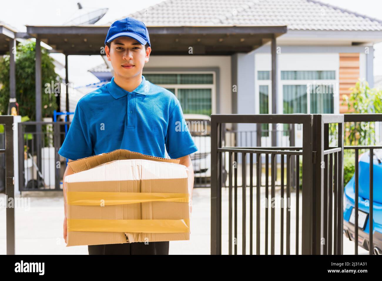 Asian young delivery man in blue uniform he emotional falling courier ...