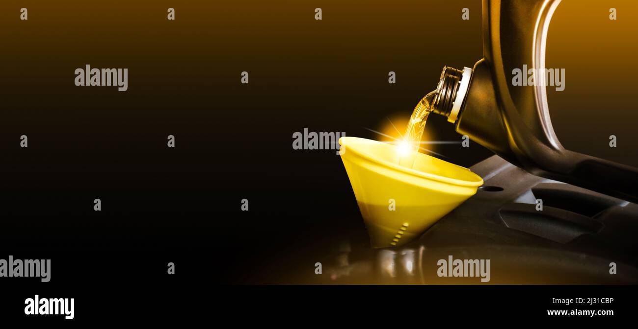 Mechanic pouring motor oil to engine with horizontal copy space on ...
