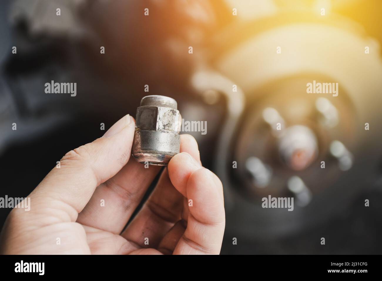 Metal nut of the car wheel in the hand Stock Photo - Alamy