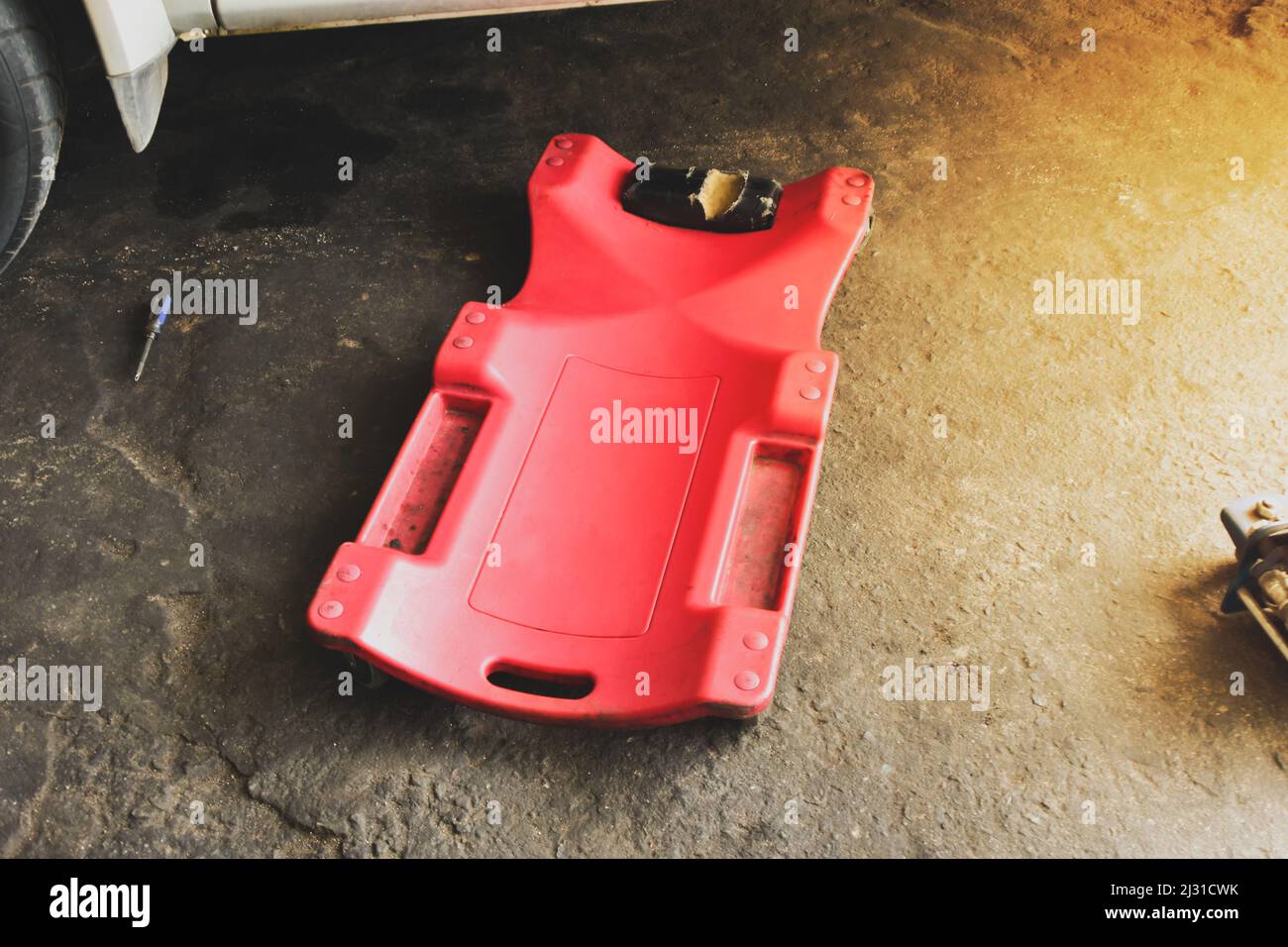 Mechanic creeper board on the floor is ready to use in the auto repair ...